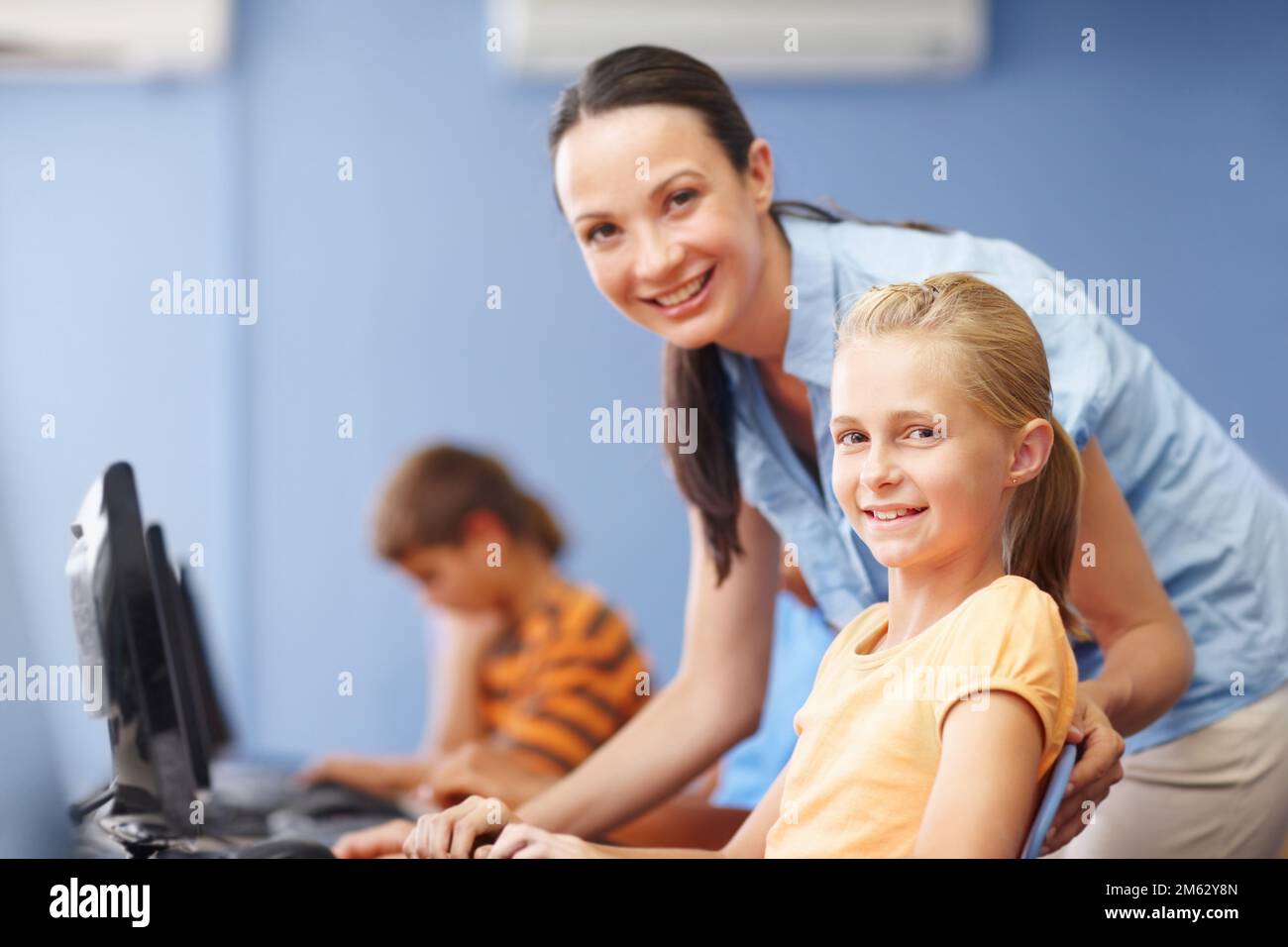 Helping her students through interactive learning. Portrait of an ...