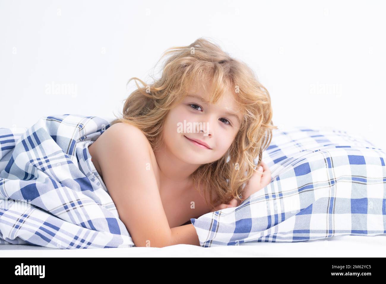 Good morning. Morning awakening little child in bed. Kid wakes up in ...