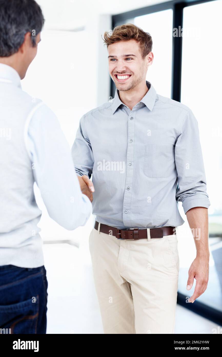 Youre making your way up. two positive-looking businessmen shaking ...