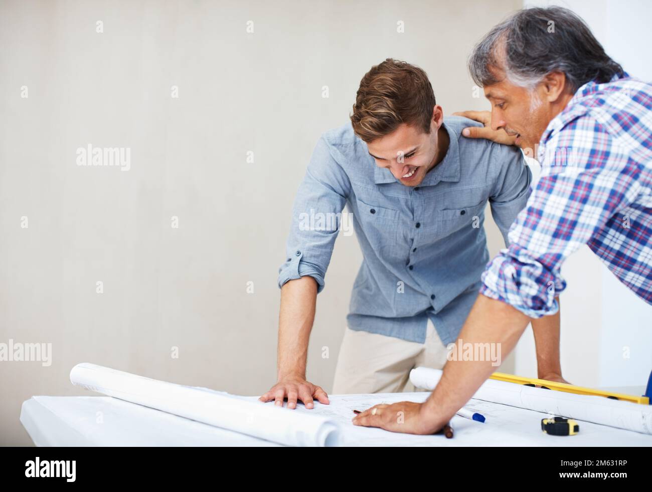 Man discussing home renovation plan with contractor. Young man ...