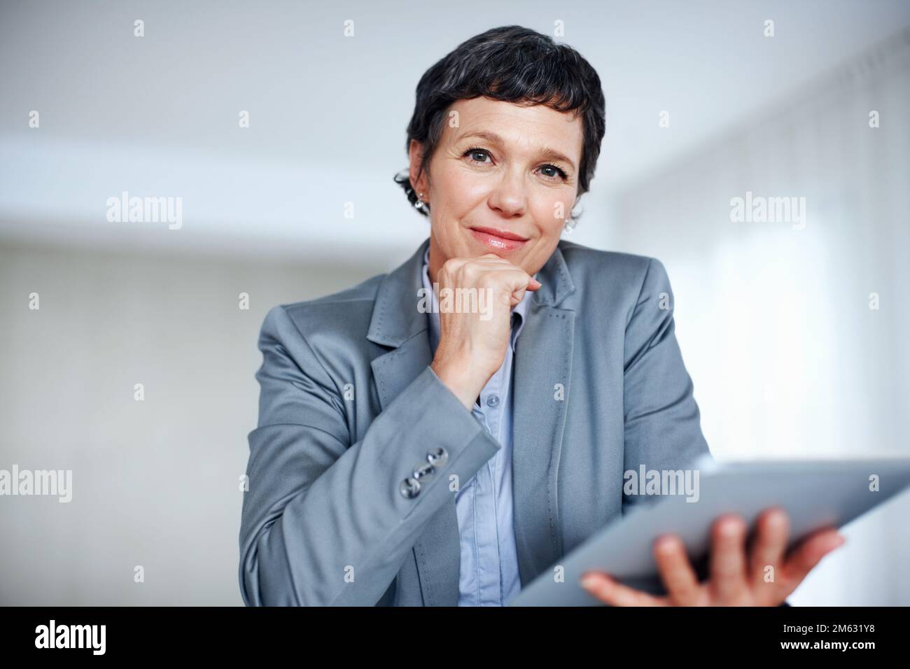 Successful business woman using tablet PC. Portrait of successful ...