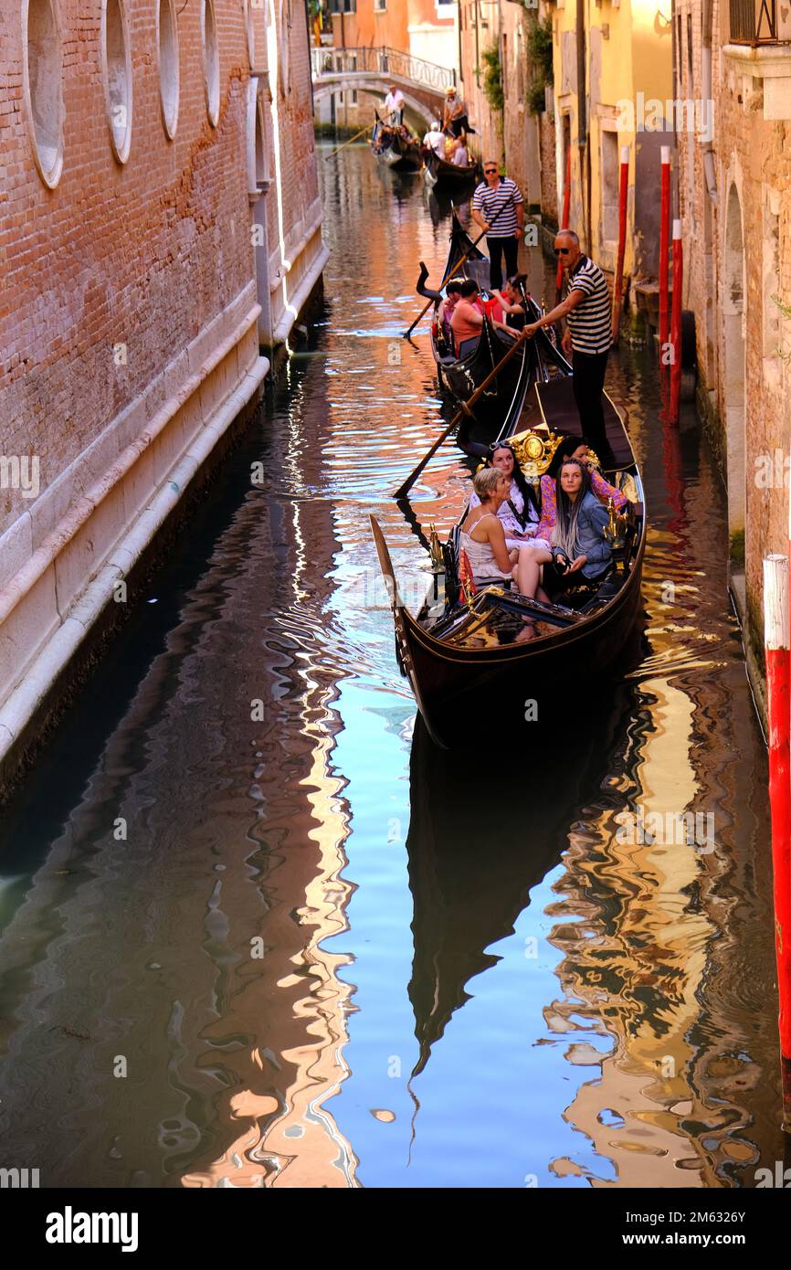 Gondolas moving along narrow canal in Venice Italy Stock Photo - Alamy