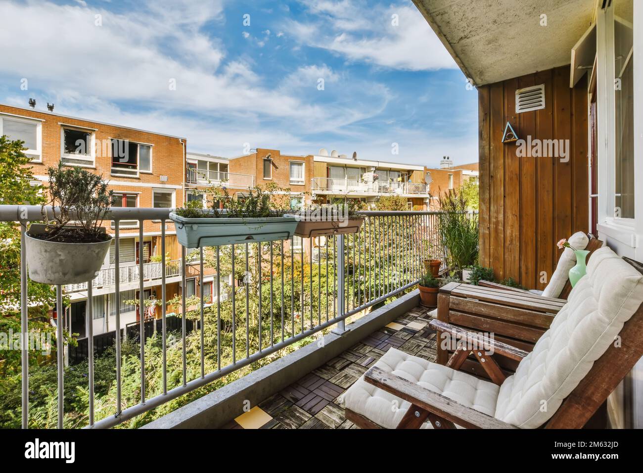 a balcony with chairs and plants on the balkgrounds in melbourne ...