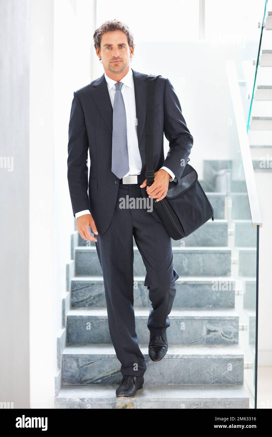 Smart executive carrying an office bag. Full length of a smart business ...