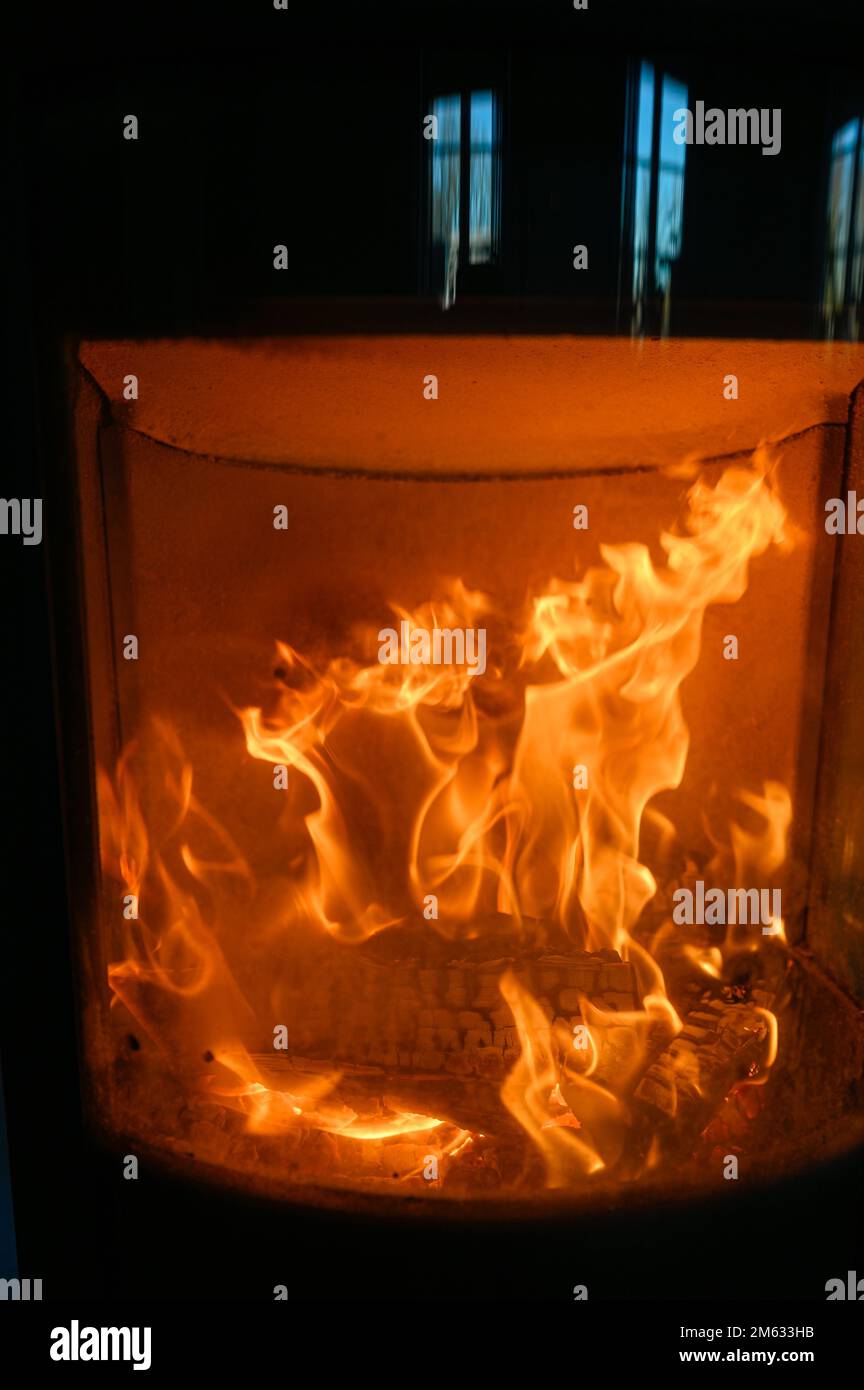 Wood burning in fireplace reflection hi-res stock photography and ...