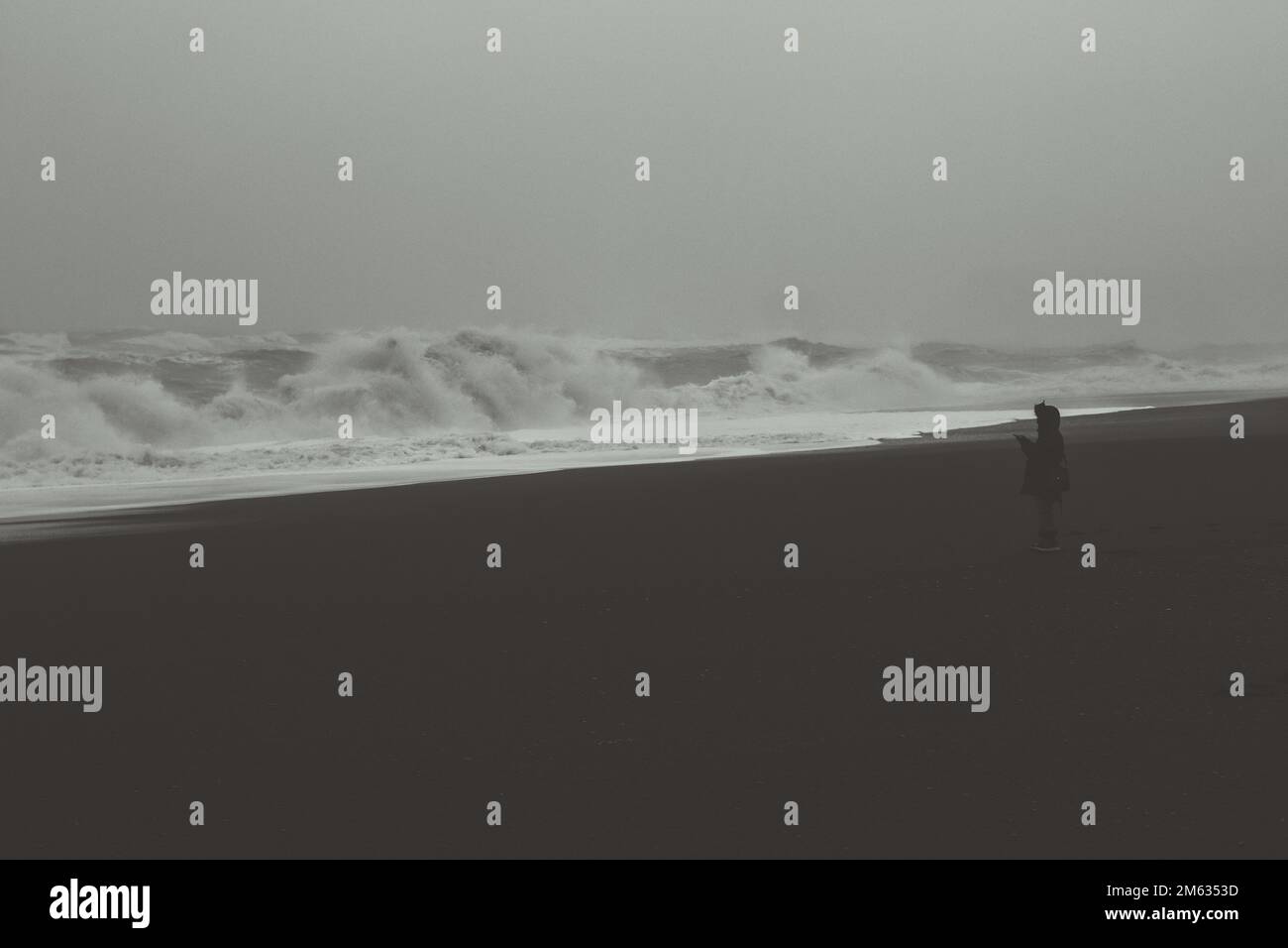 Person at stormy seaside monochrome landscape photo Stock Photo - Alamy