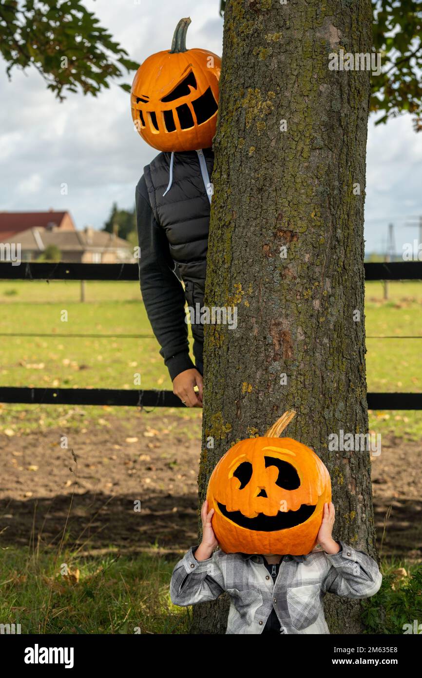 A vertical shot of people with carved pumpkin heads Stock Photo - Alamy