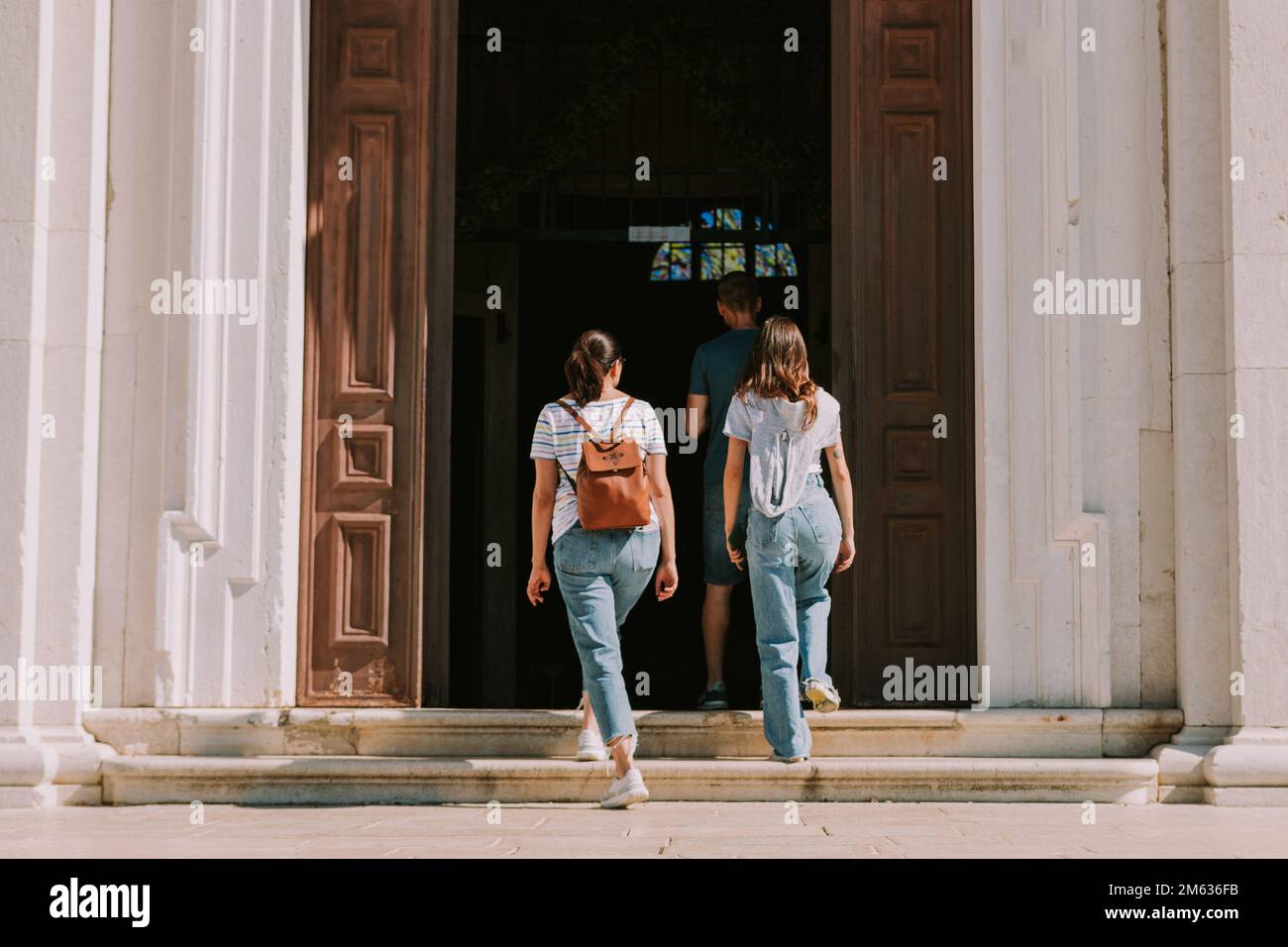 Two girls entering an old church Stock Photo - Alamy
