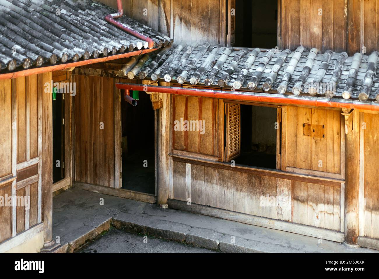 Exterior of aged wooden pagoda with log roofs and carved windows on ...