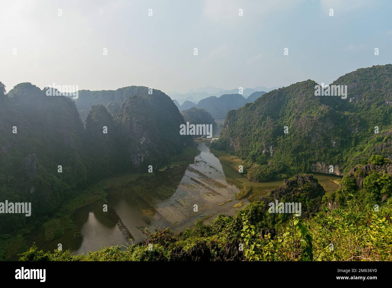 From above scenic view of narrow river flowing through hills covered ...