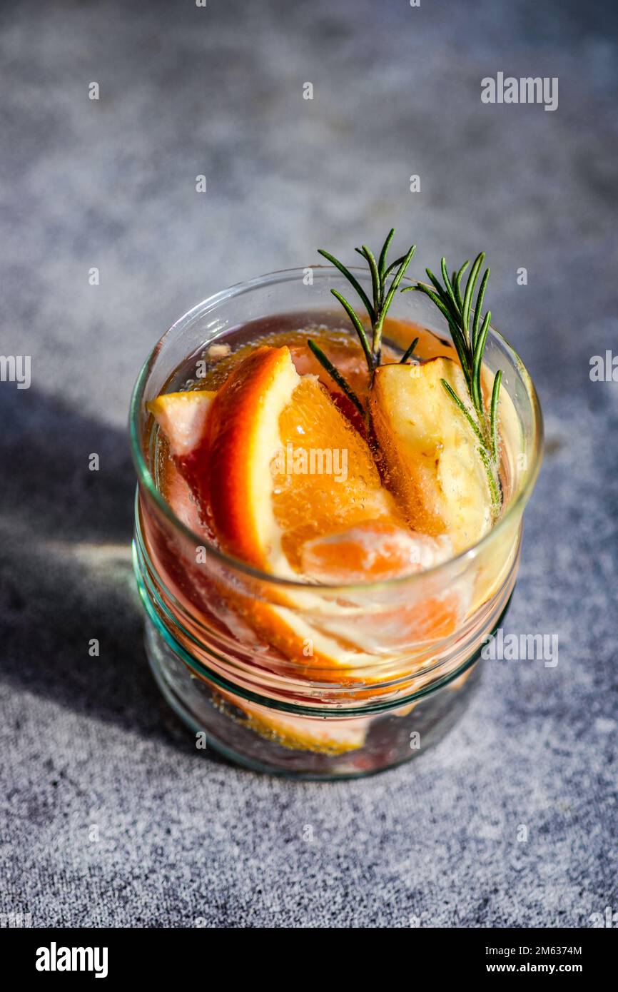 Summer tropical cocktail of vodka and sprite with ripe fruits and ...