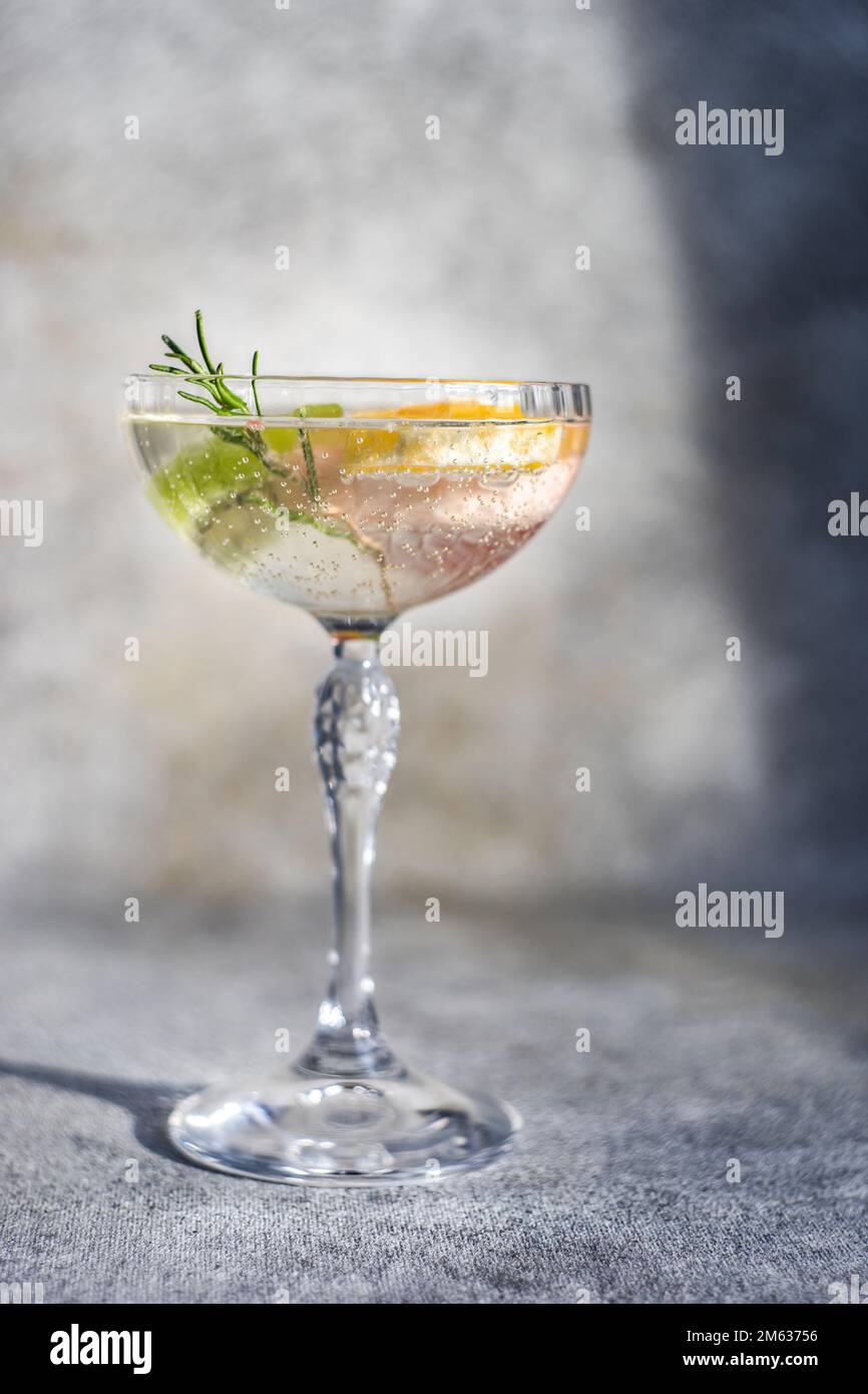 Summer tropical cocktail of vodka and sprite with ripe fruits and ...