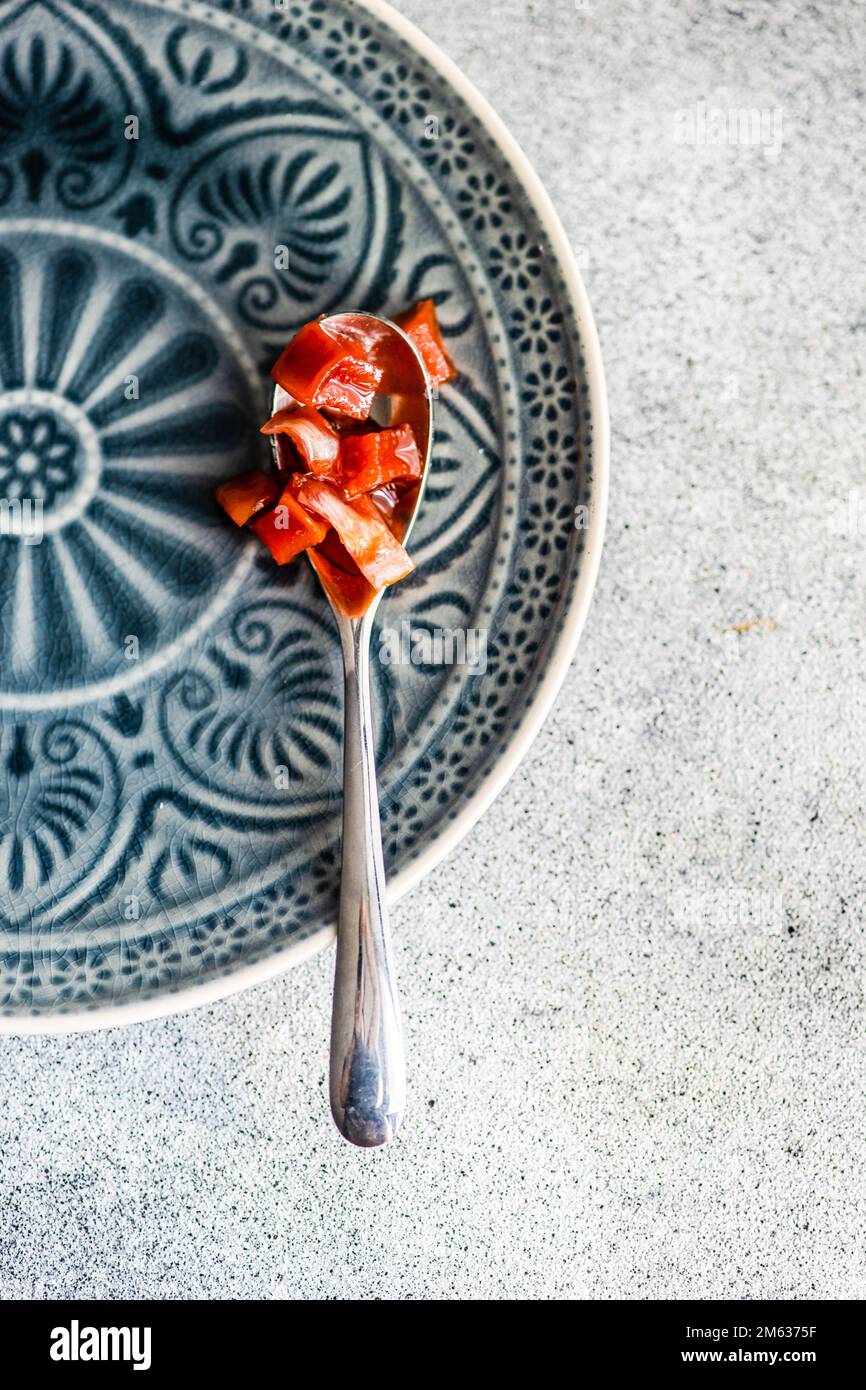 From above vintage ceramic plate with spoon with peach jam on the ...