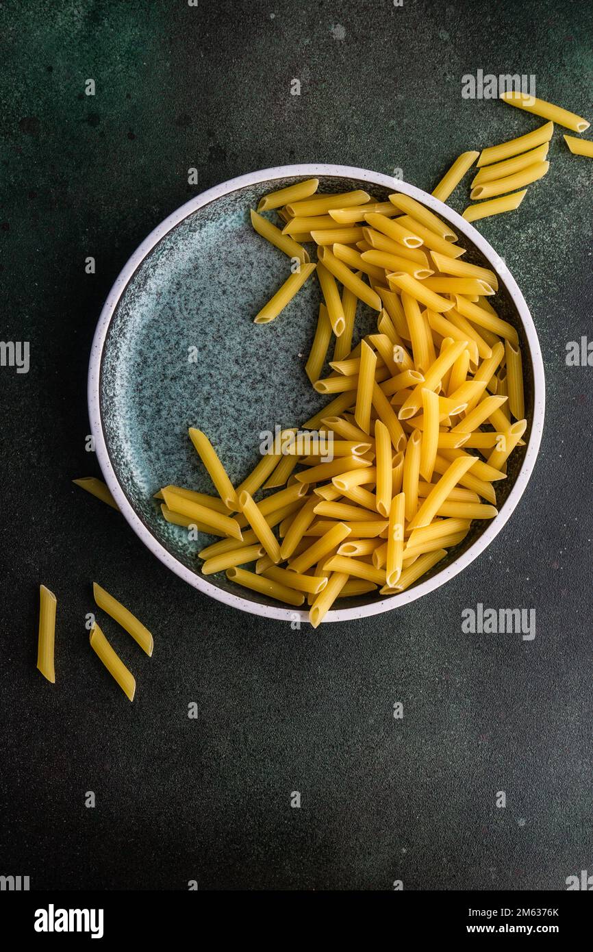 From above uncooked raw penne pasta on the plate Stock Photo - Alamy