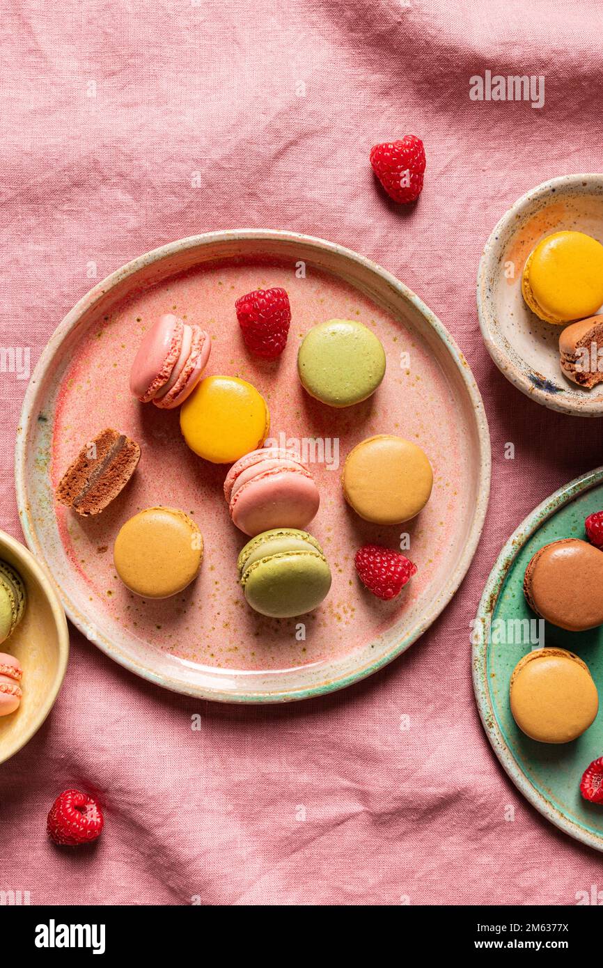 Top view of assorted round plates with various of sweet colorful French ...