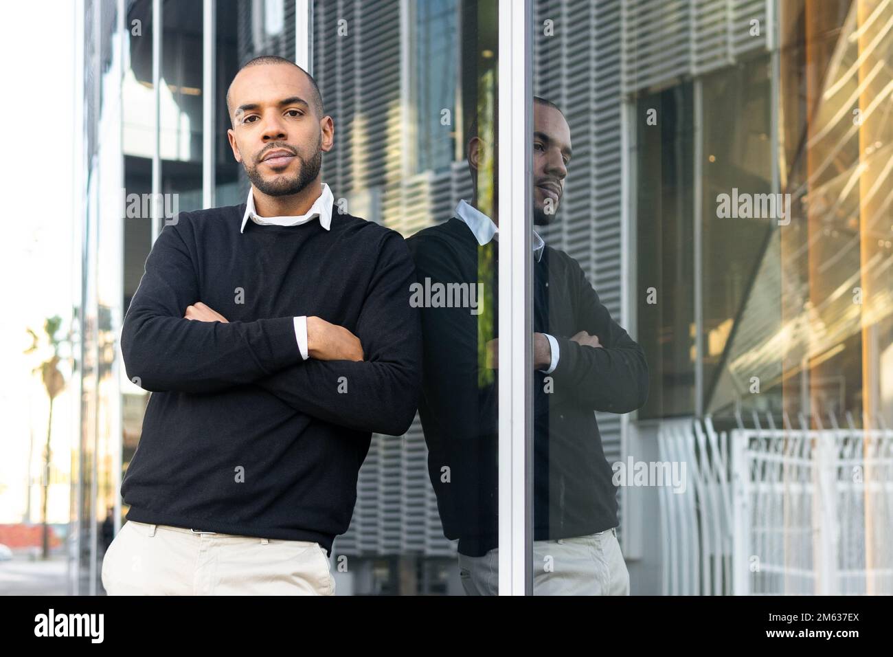 Serious young bearded male executive in smart casual outfit looking at ...