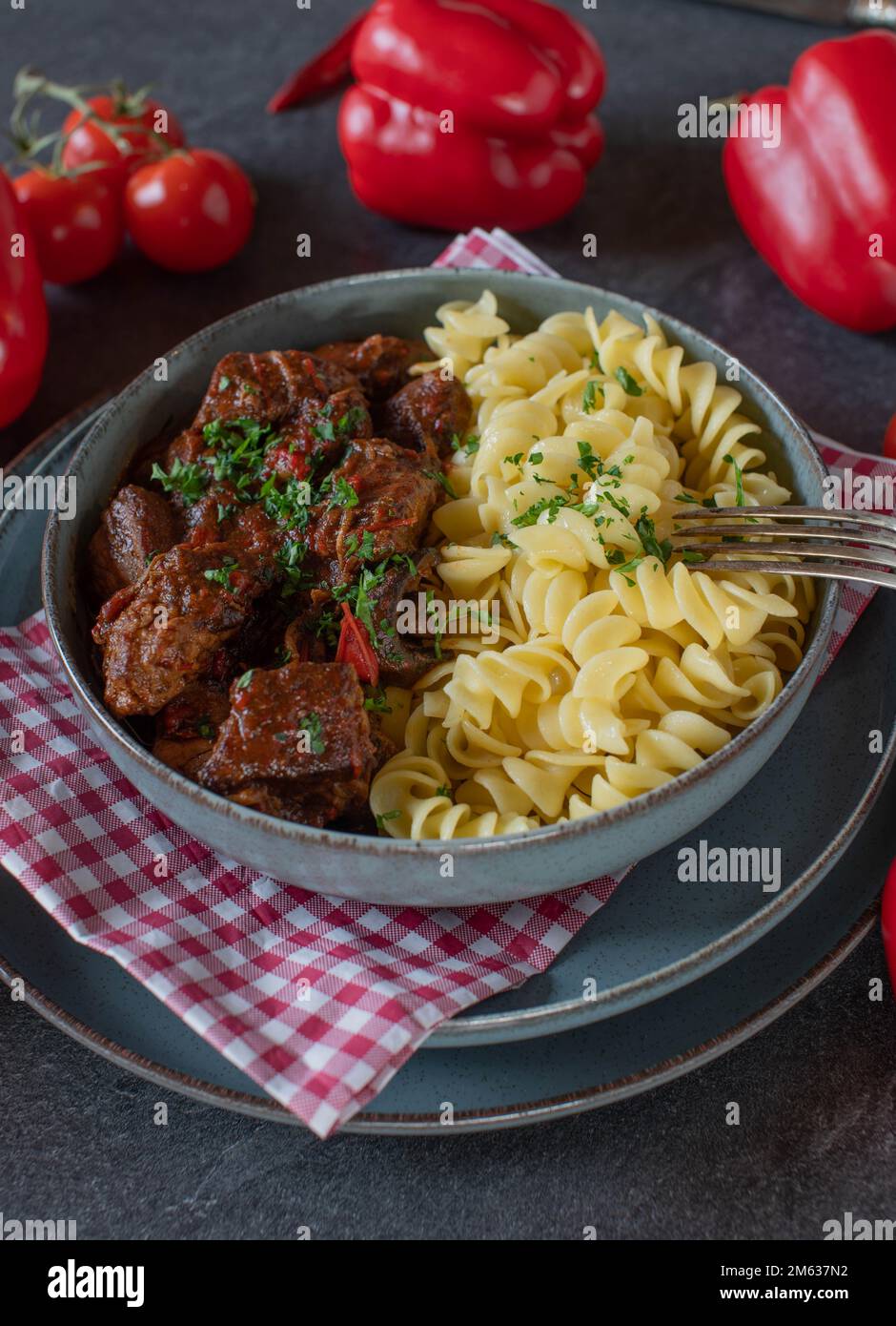 Hungarian goulash with pasta on a plate Stock Photo - Alamy