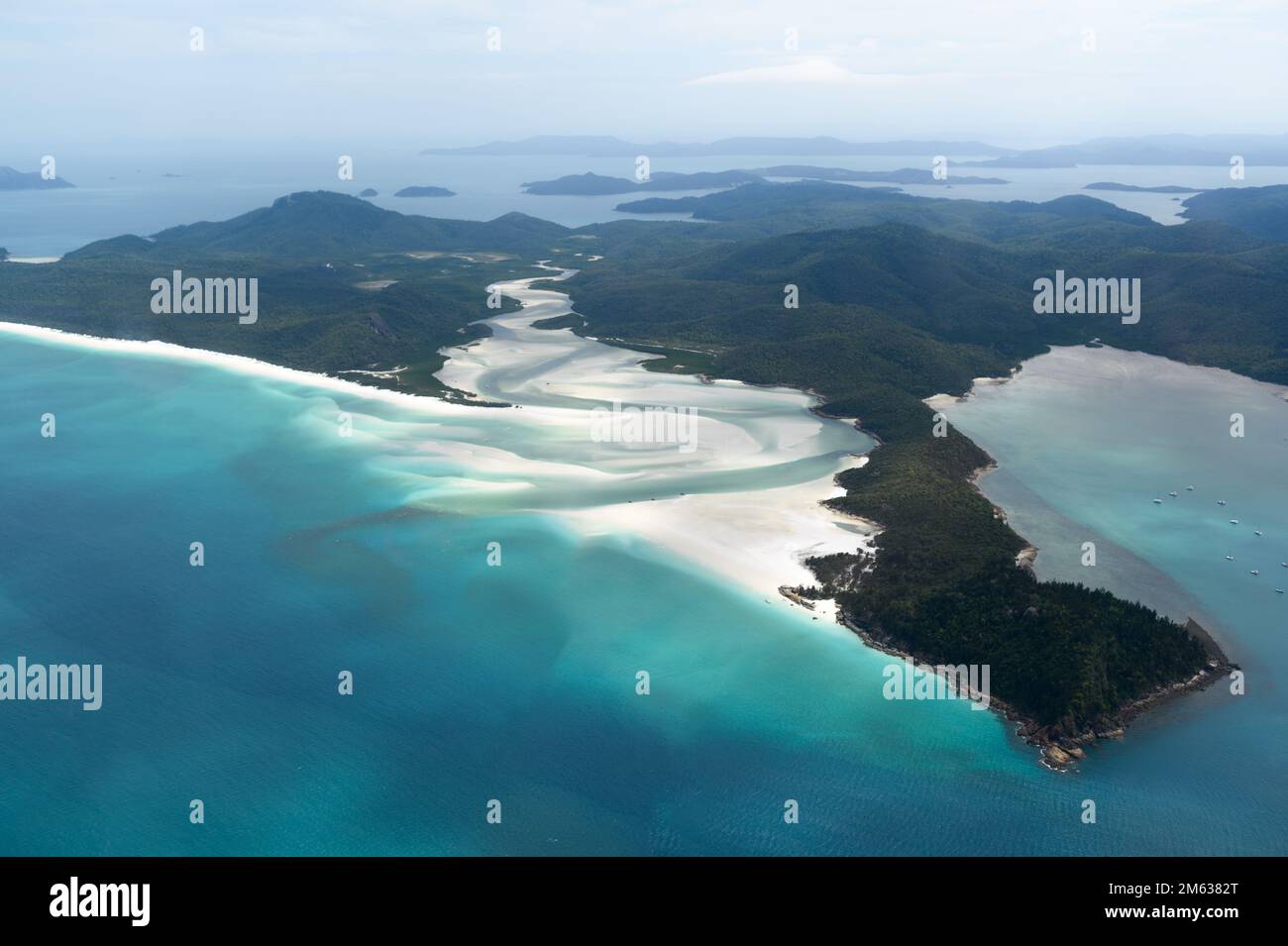 Aerial view of picturesque island surrounded by azure seawater under ...