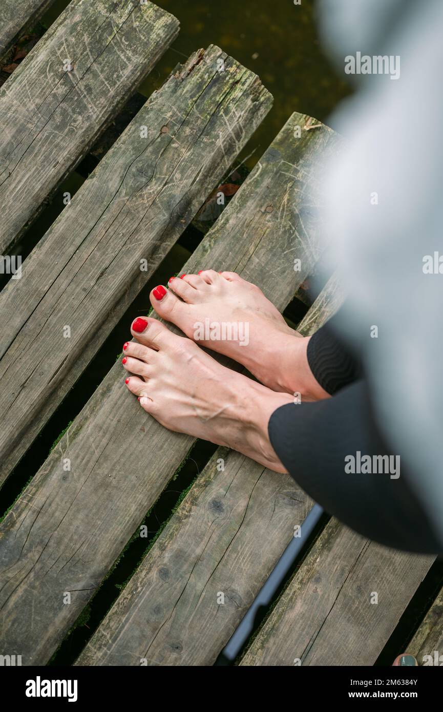 From above of pedicured crop anonymous females feet with red nail ...