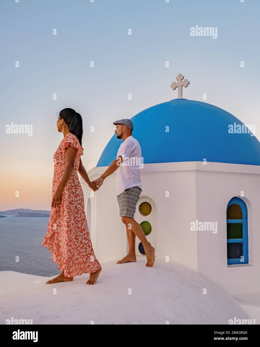 A couple on vacation in Santorini Greece, two men and women visit Oia ...