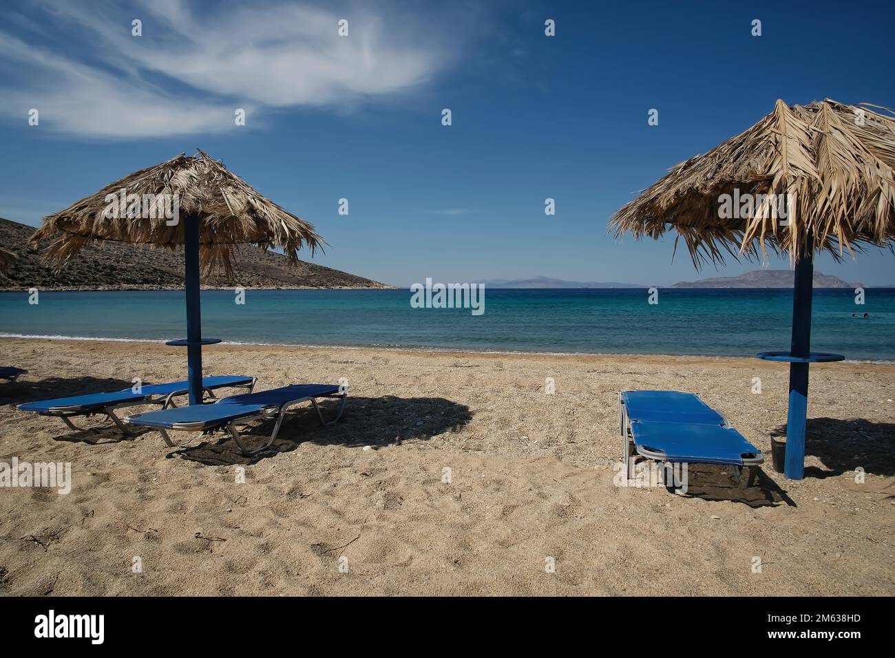 Sun beds and a sun umbrellas at the amazing beach of Agia Theodoti in ...