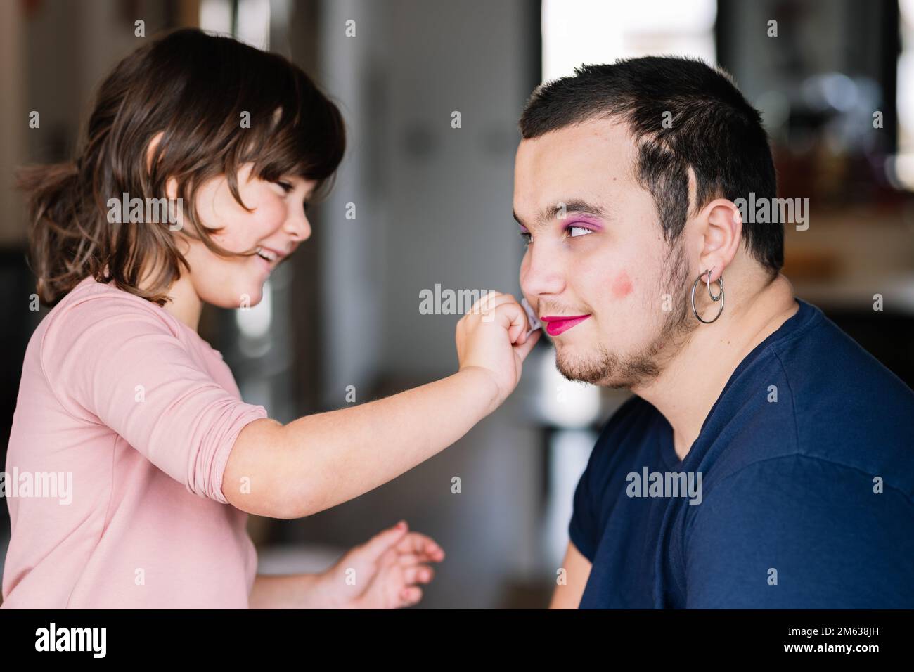 Side view of adorable little girl with ponytail in pink sweater ...