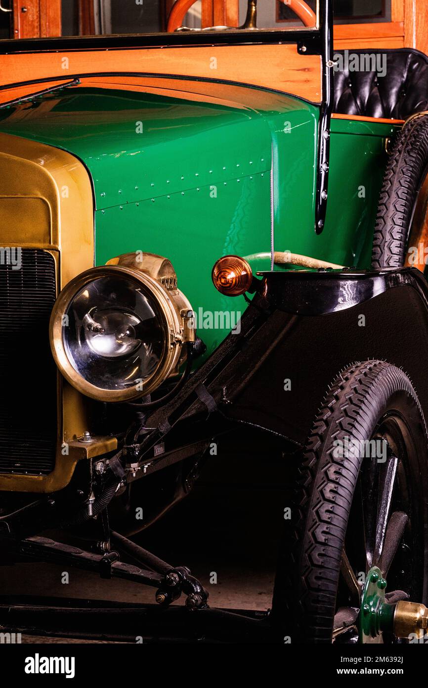 Round shaped headlight and large wheels of vintage green and yellow ...