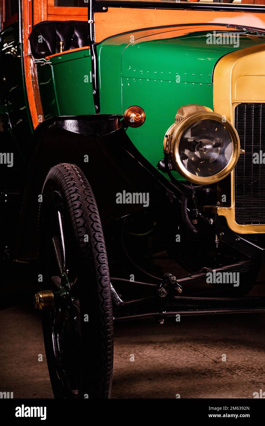 Round shaped headlight and large wheels of vintage green and yellow ...