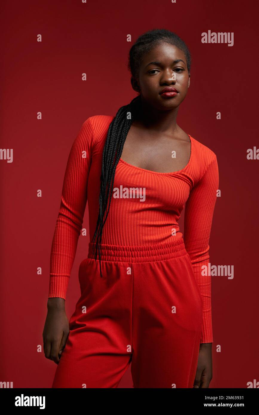 Self assured black female model with long dark hair in dreadlocks ...