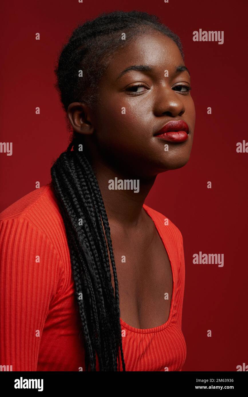 Self assured black female model with long dark hair in dreadlocks ...
