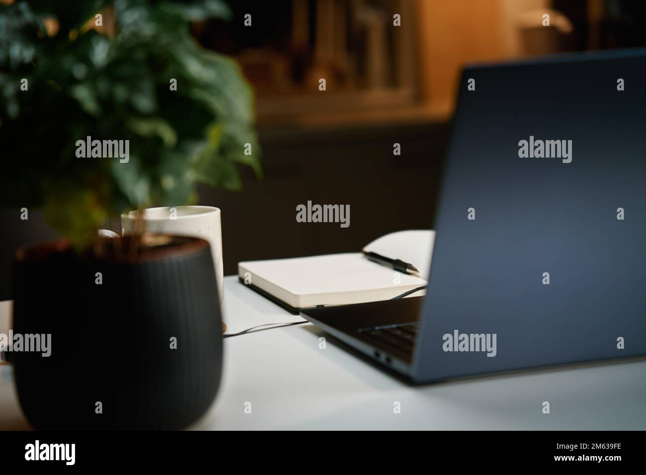 Empty workplace at home office at night. Laptop on table in living room ...