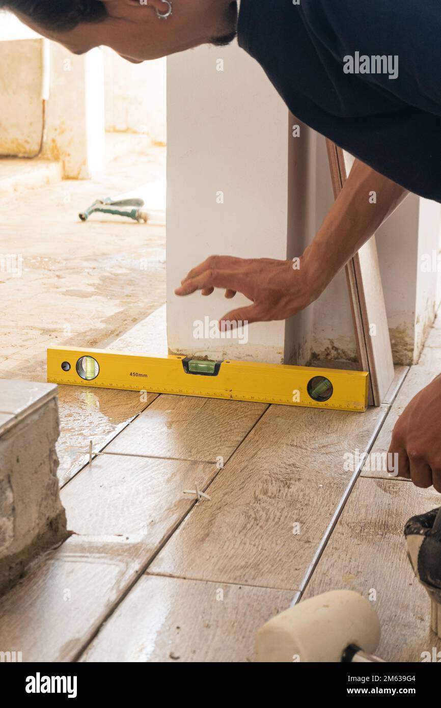 High angle of adult male worker in black t shirt sitting on floor and ...