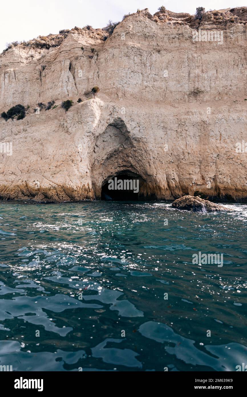 Picturesque scenery of massive rocky cliffs near blue rippling sea ...