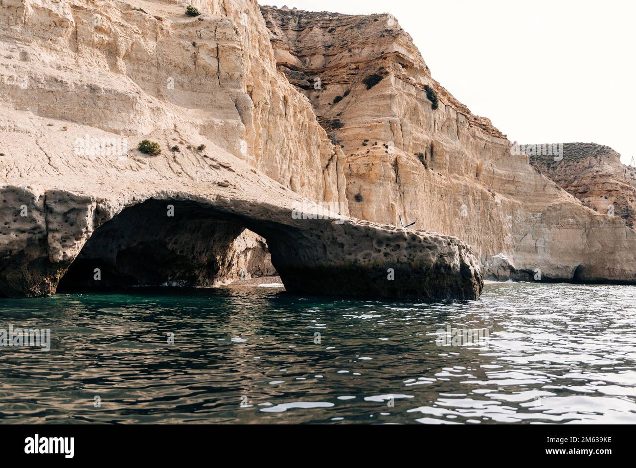 Picturesque scenery of massive rocky cliffs near blue rippling sea ...