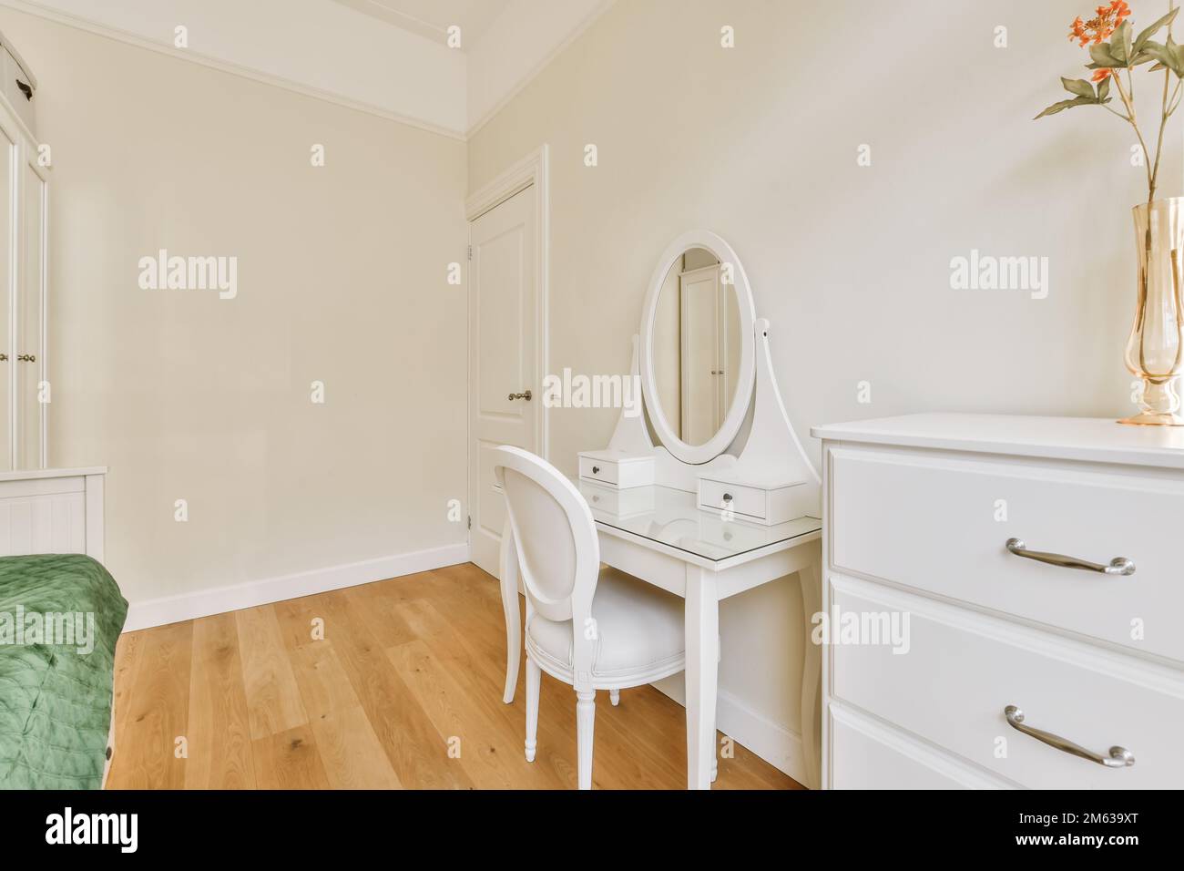 Comfortable green sofa with cushions placed at wall in light room with ...