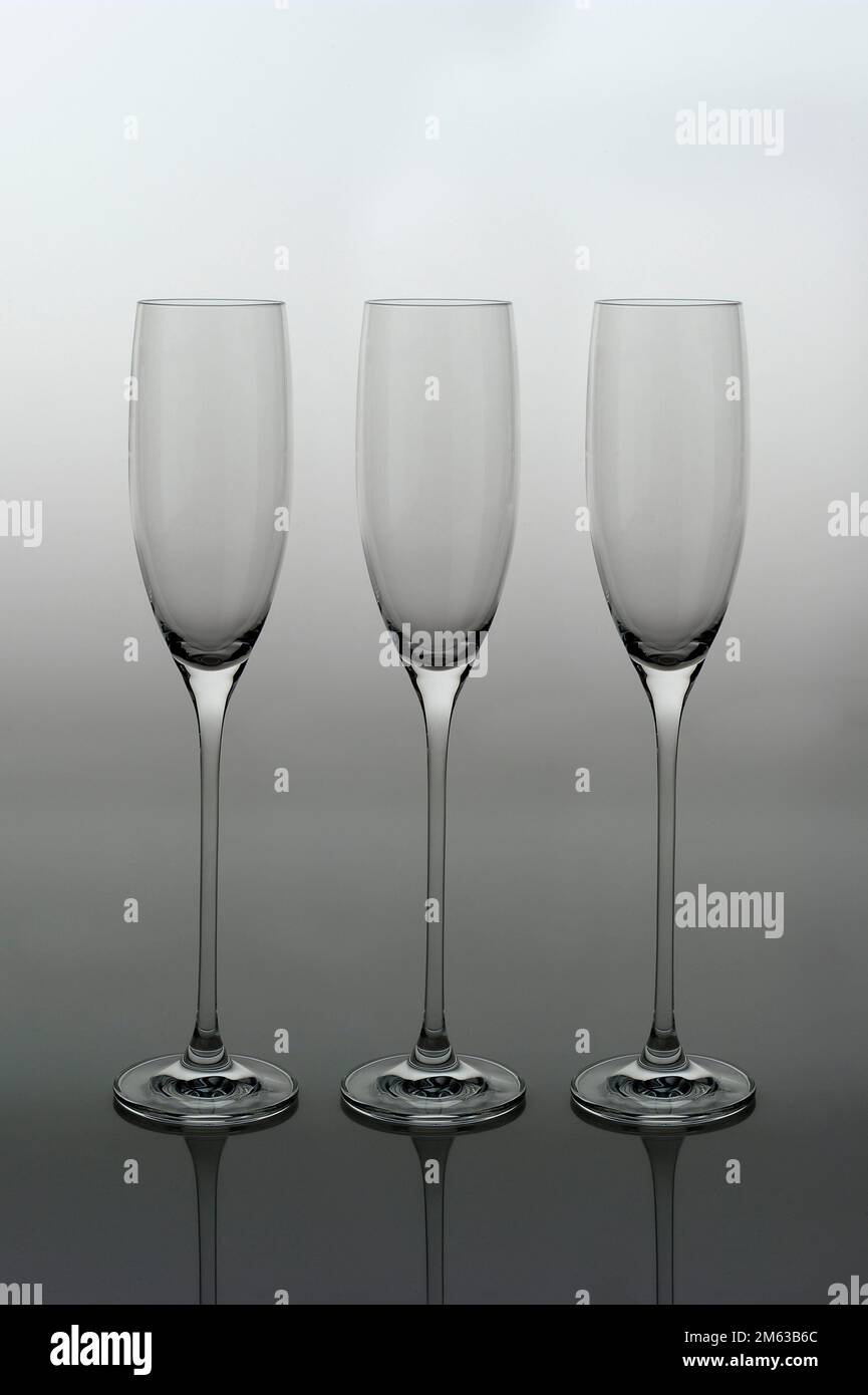 Three crystal Champagne glasses photographed backlit on vertical ...