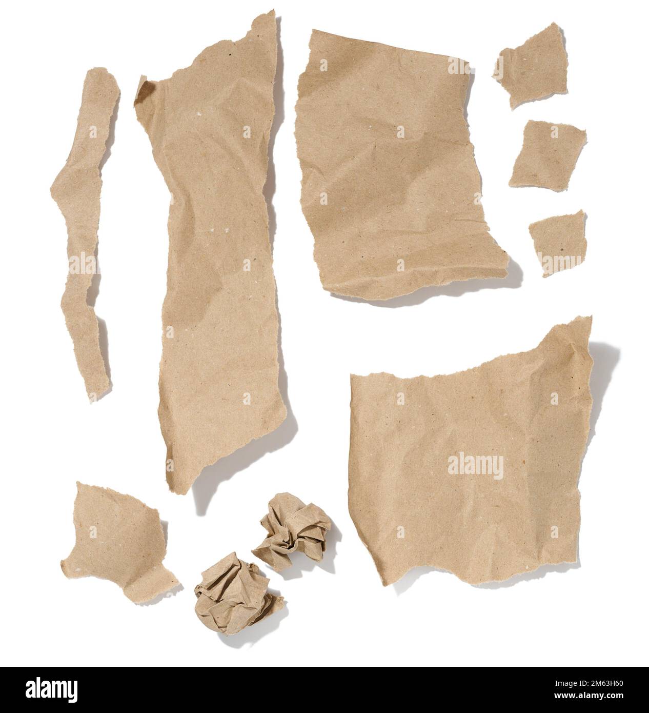 Various torn strips of brown wrapping paper on a white isolated ...