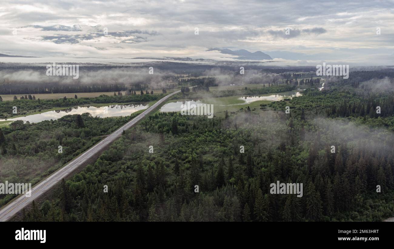An aerial shot of a river under a cloudy sky in Invermere, BC, Canada ...