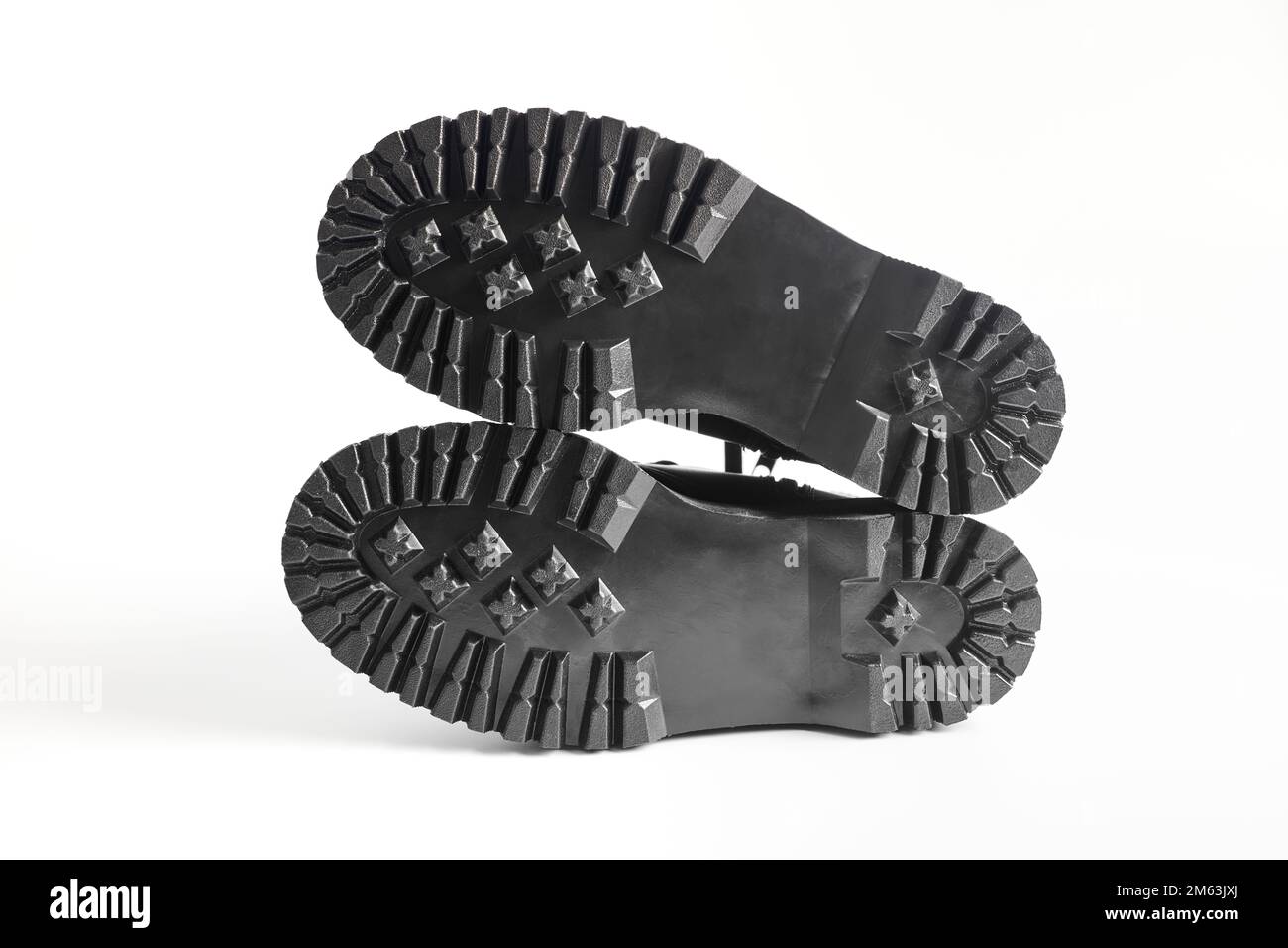 Lug soles of black combat boots on high heel platform lying on isolated ...