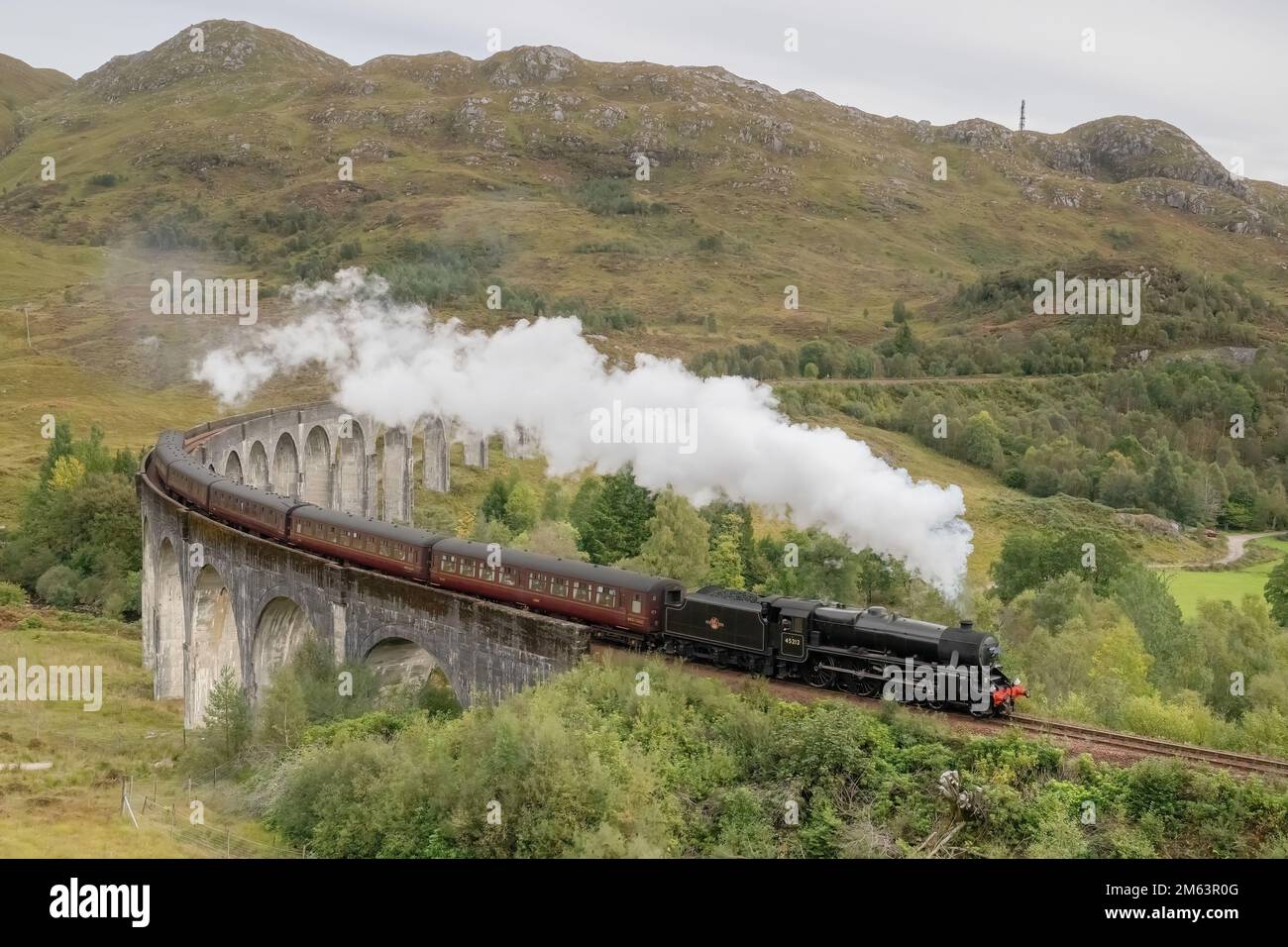 Glenfinnan Railway Viaduct with a steam train crossing the famous ...