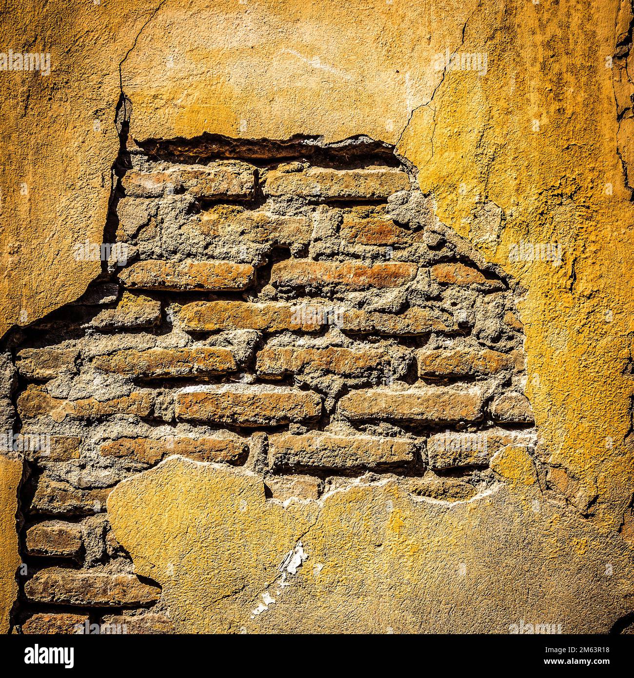 The plaster fell off the old brick wall Stock Photo - Alamy