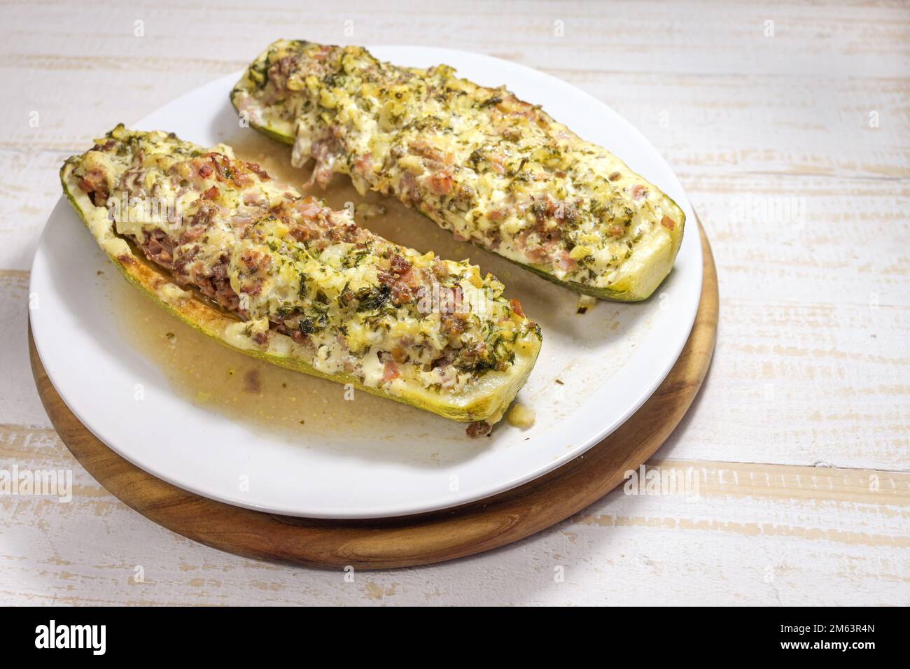 Baked zucchini or courgette boats stuffed with minced beef meat, onions ...