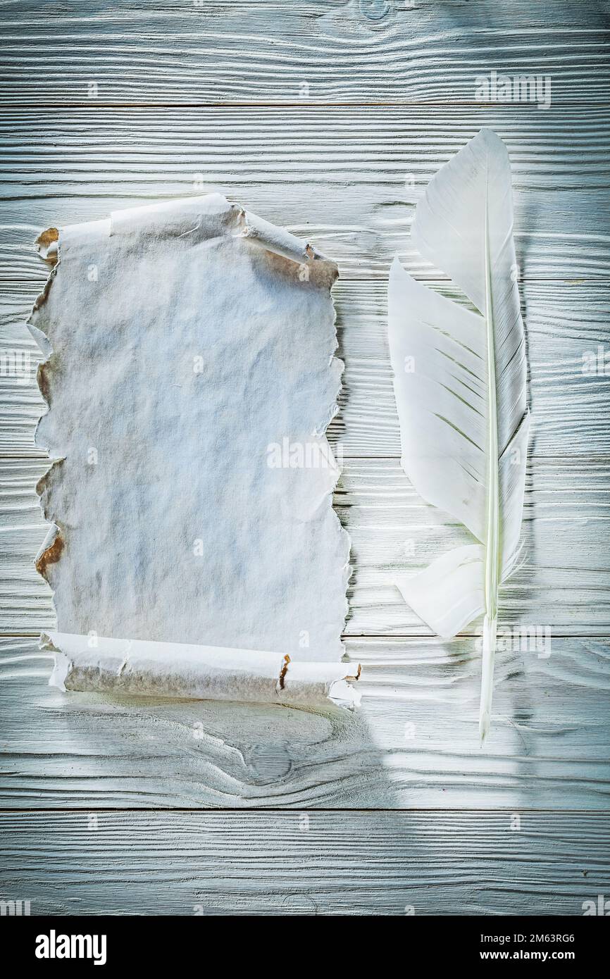 Vintage crumpled paper scroll feather on wooden board top view Stock ...