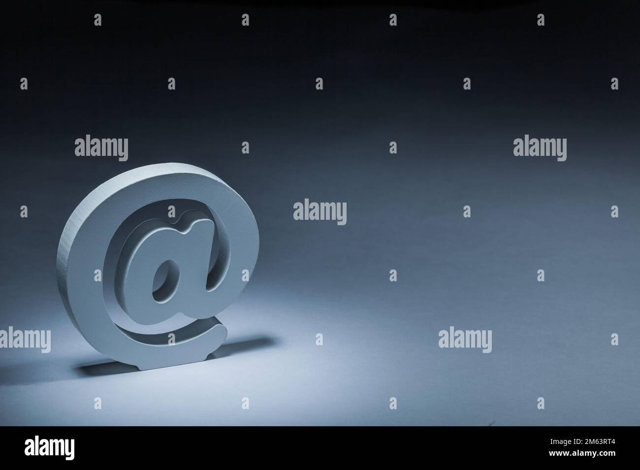 white email post symbol with lighting from top Stock Photo - Alamy