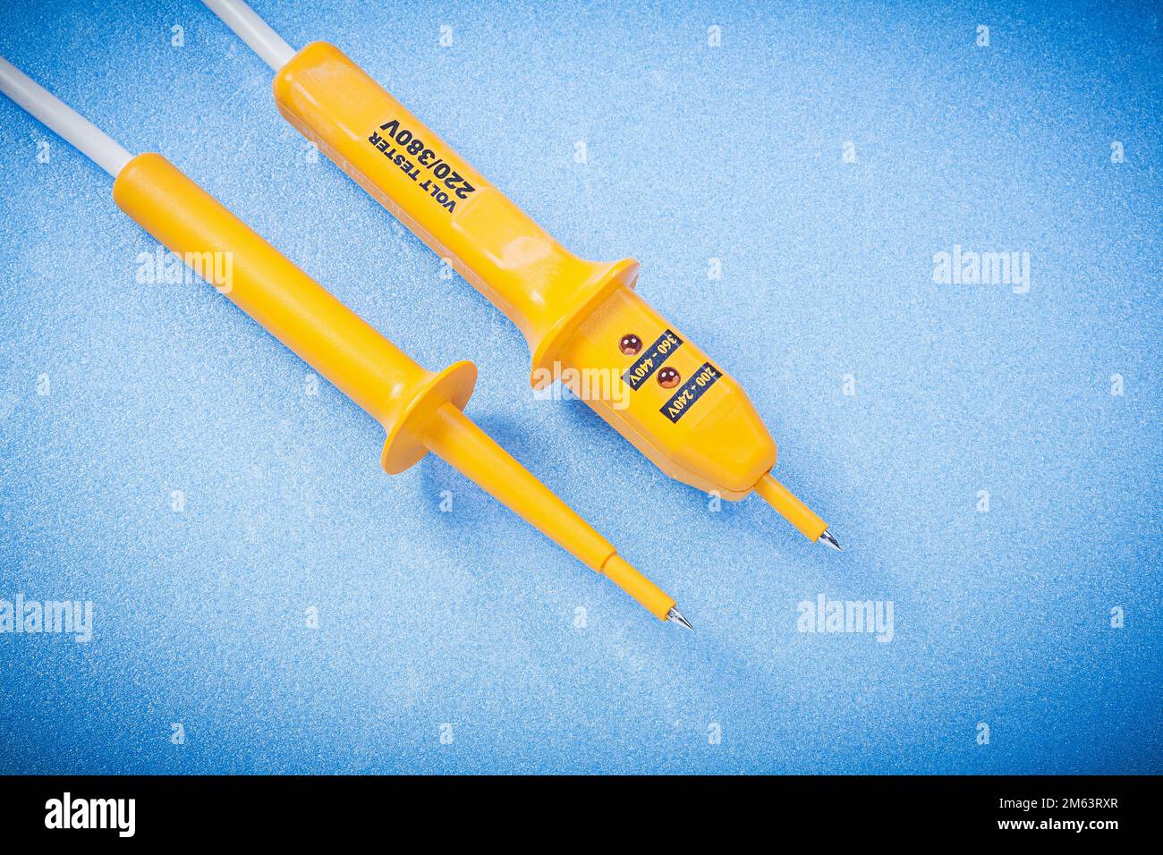 Yellow electrical tester on blue background horizontal view electricity ...