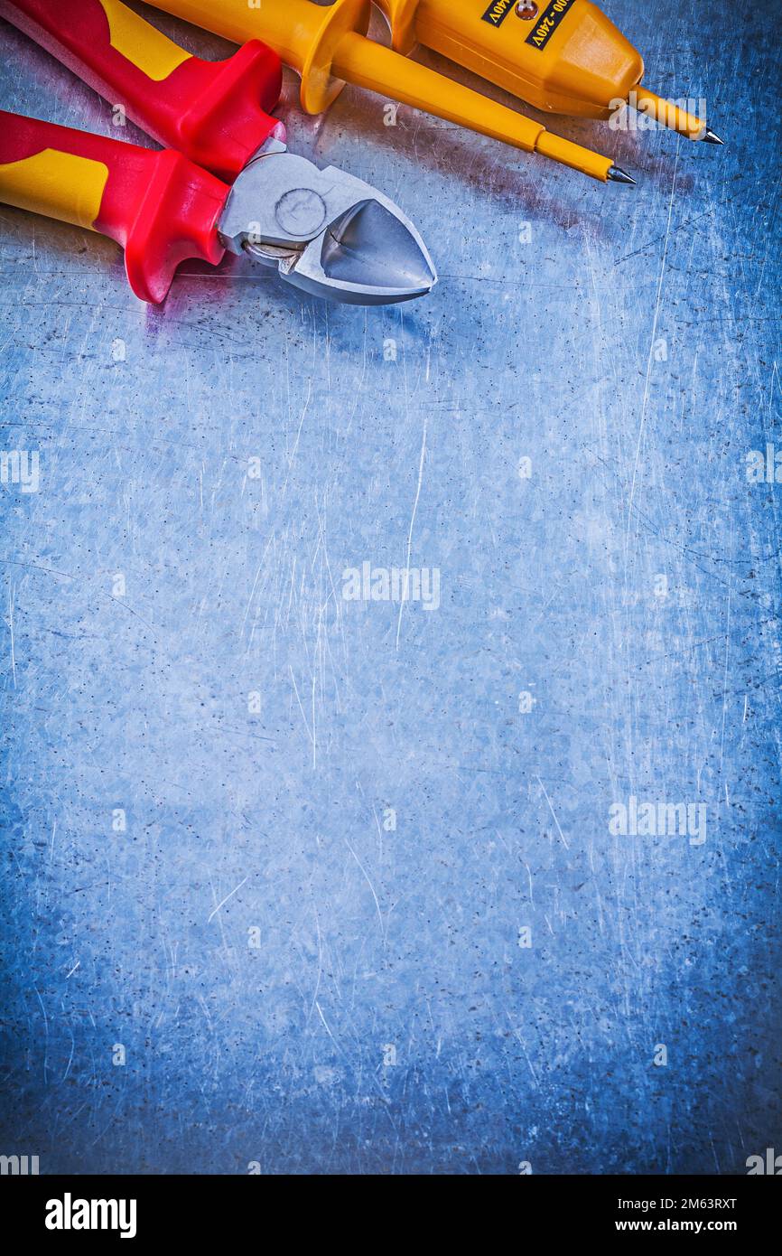 Yellow electrical tester nippers on metallic background electricity ...