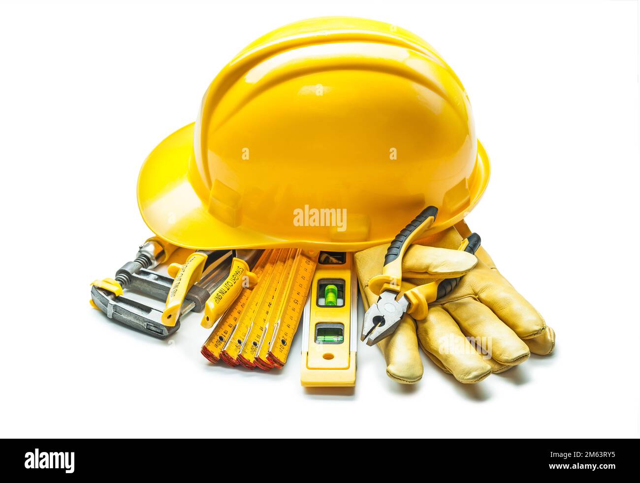 yellow construction tools under helmet isolated Stock Photo - Alamy