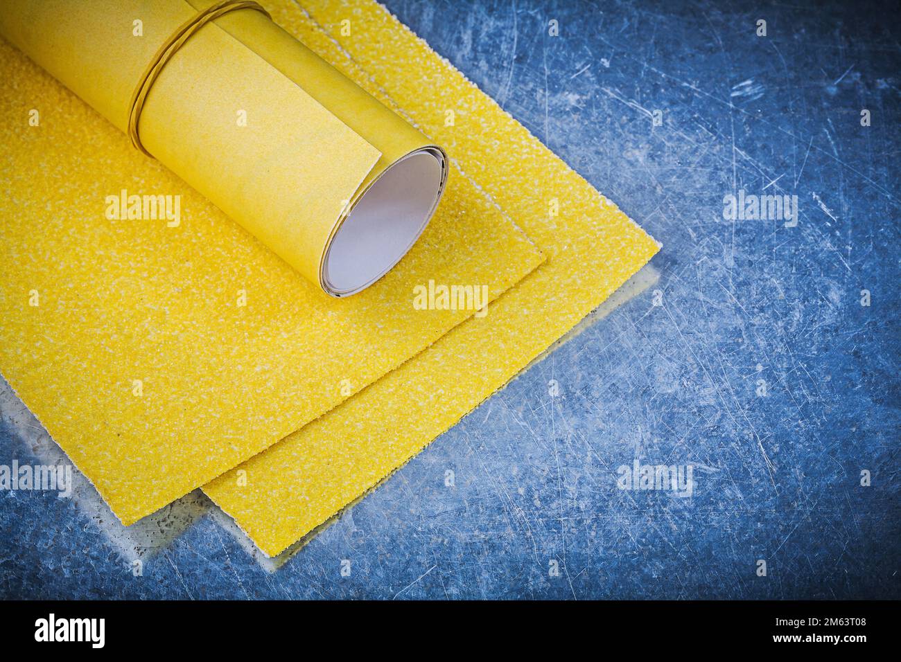 Yellow glass-paper on scratched metallic background abrasive materials ...
