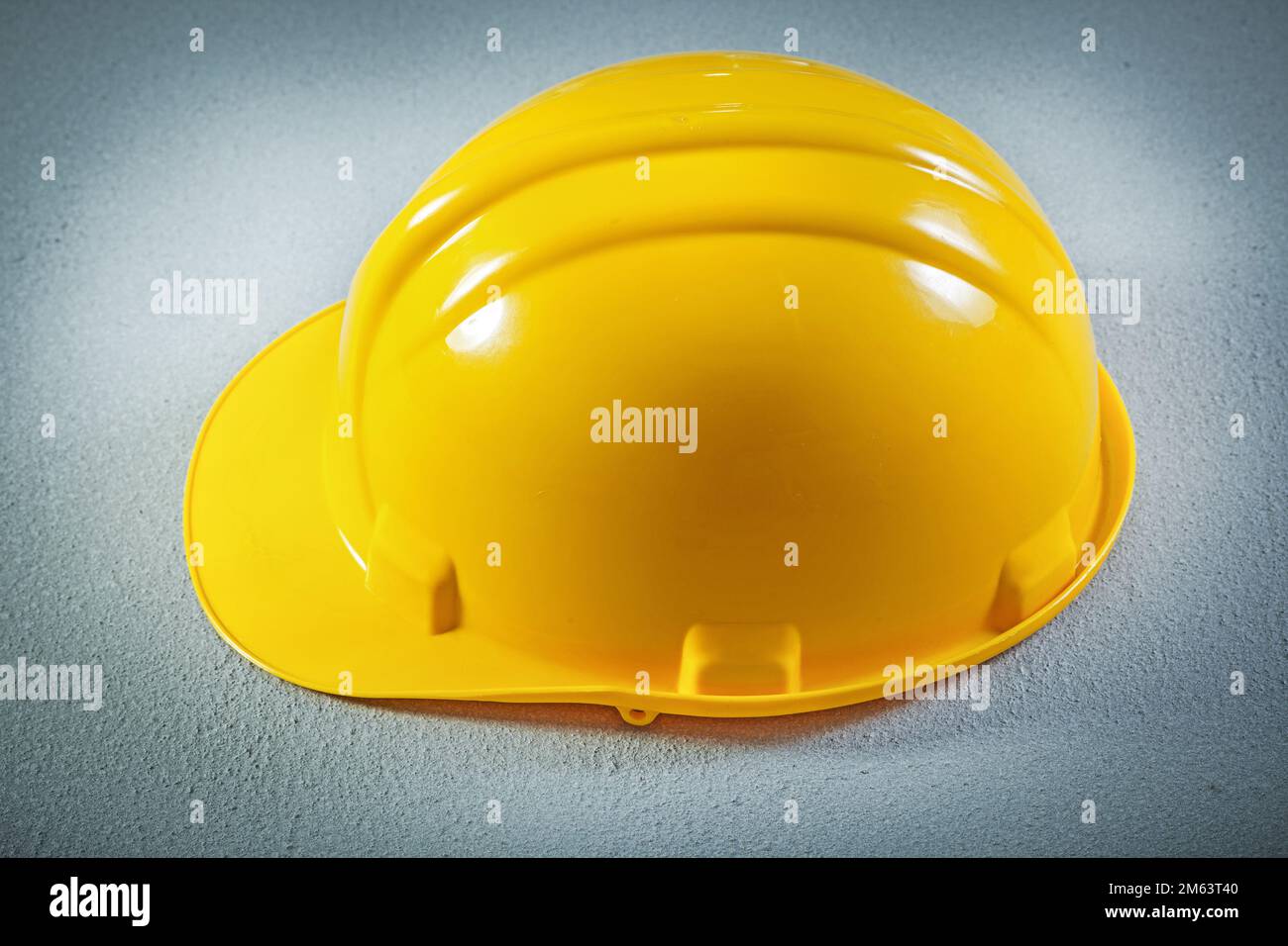 Yellow safety cap on concrete background construction concept Stock ...