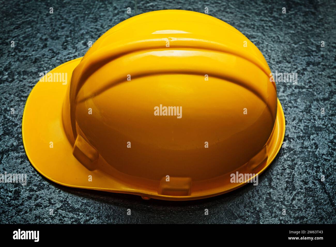 yellow helmet on black background Stock Photo - Alamy
